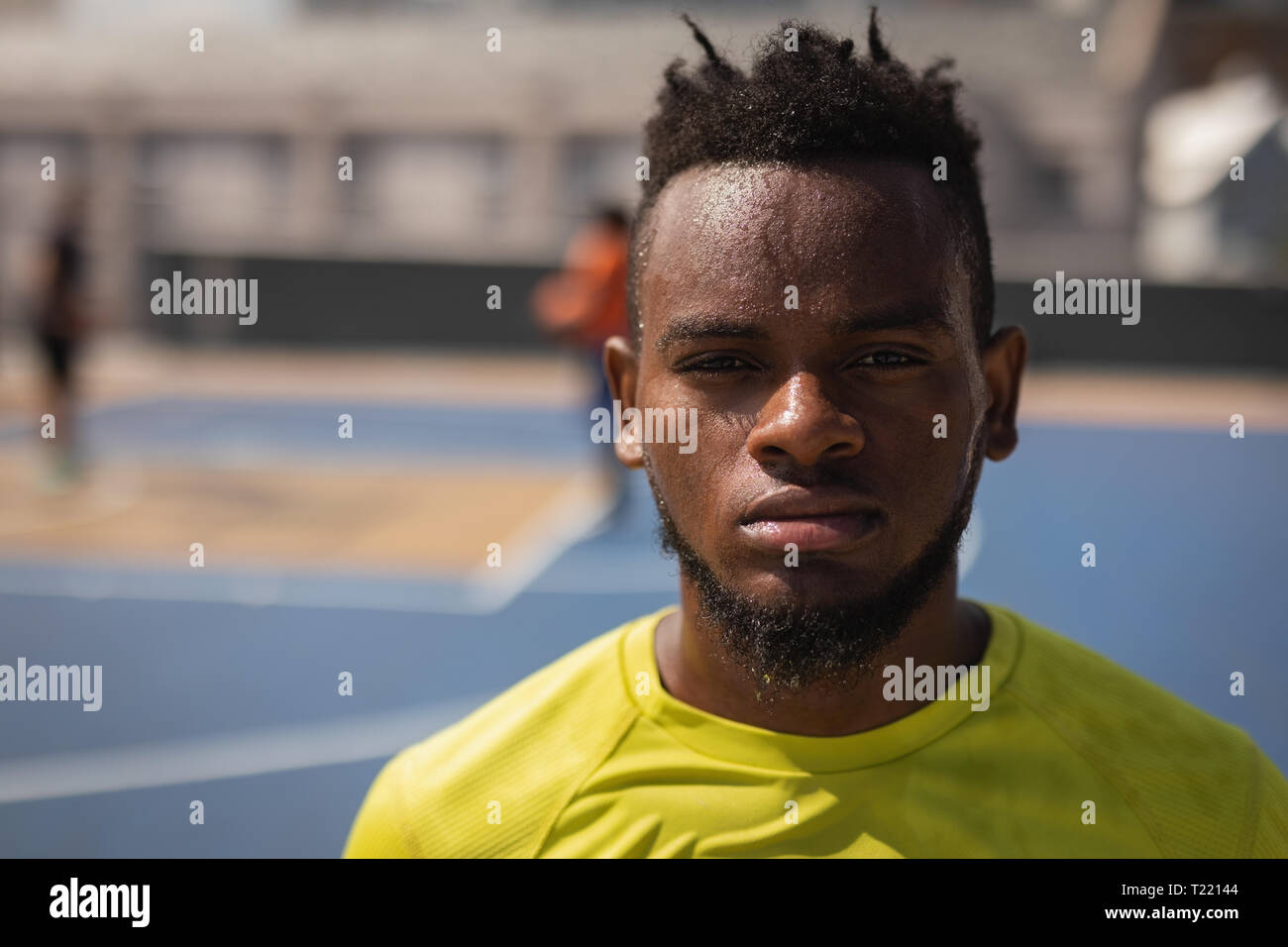 Basketball player looking at the camera on a basketball court Stock ...