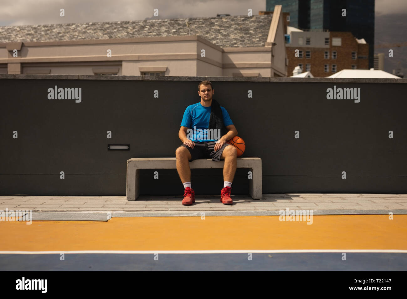 Confident player relaxing in basketball court at bench Stock Photo - Alamy