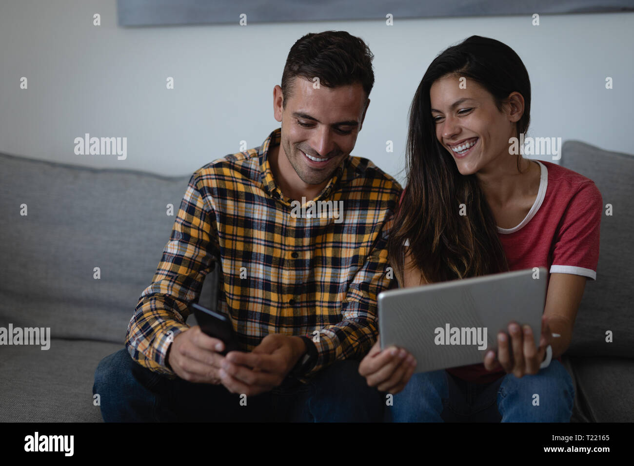 Couple using smartphone talking sitting hi-res stock photography and ...