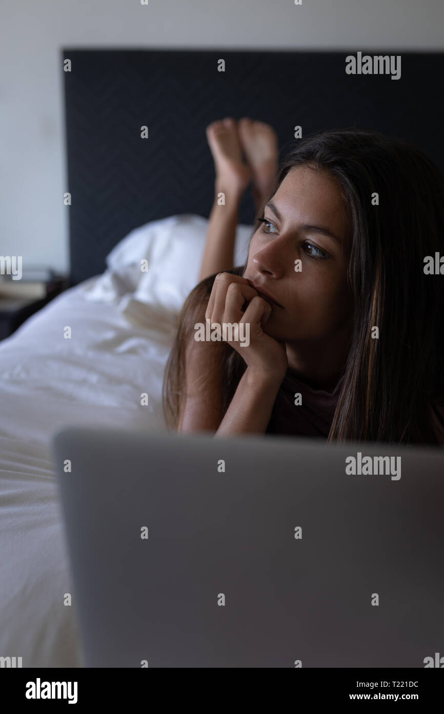 Woman on bed with laptop hi-res stock photography and images - Alamy