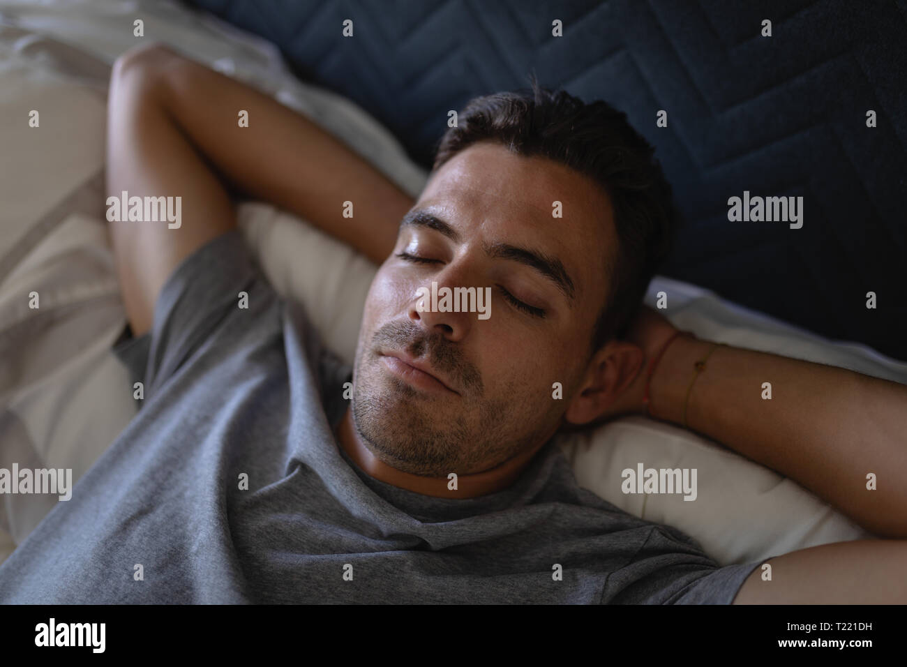 Handsome man lying on bed hi-res stock photography and images - Alamy