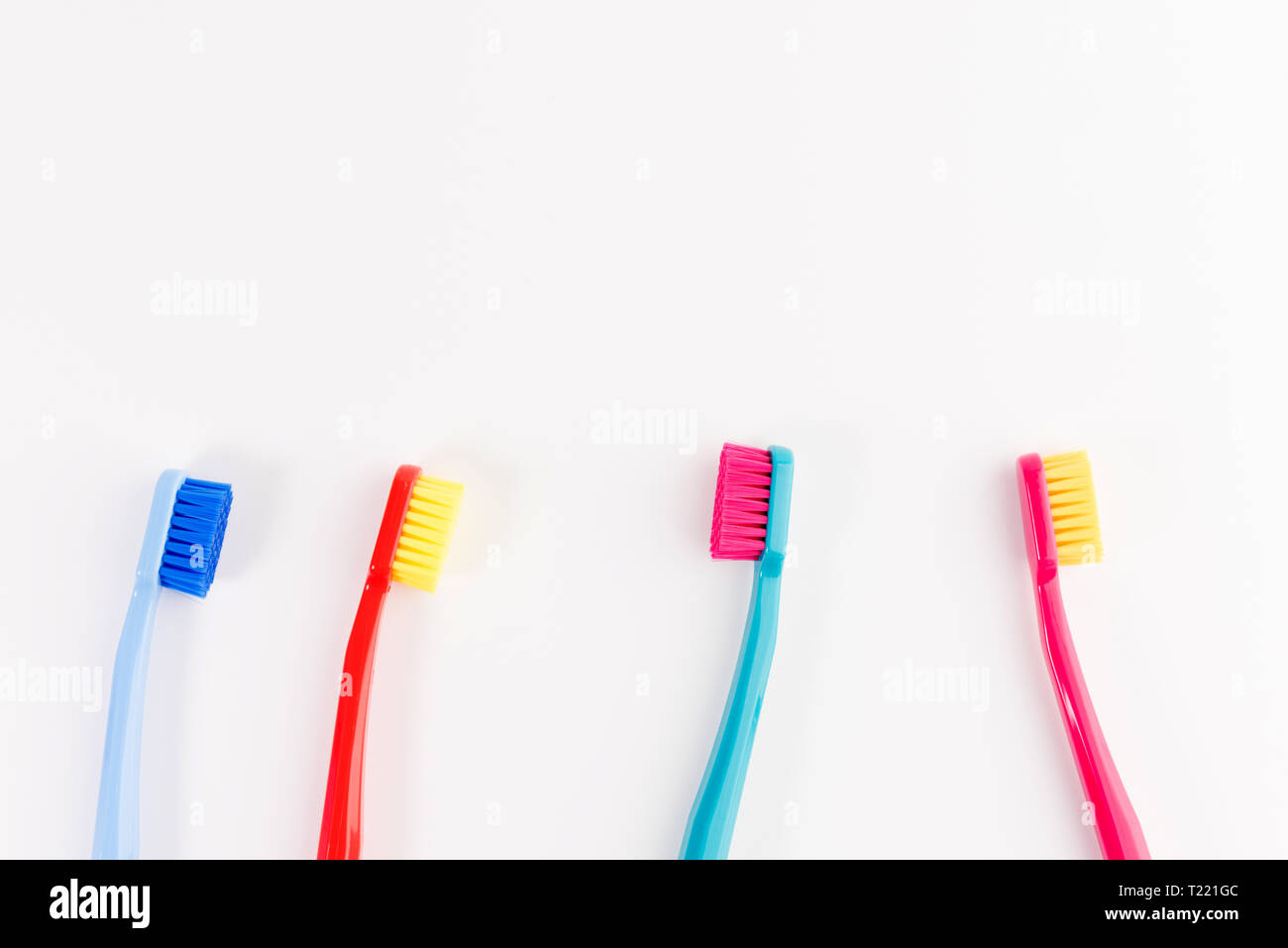 Red, pink, blue and light blue toothbrushes. Taking care of teeth ...