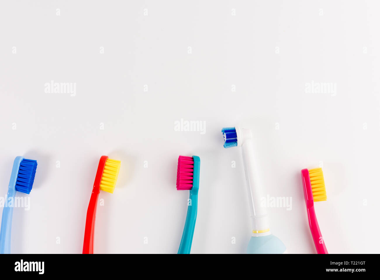 Red, blue, light blue and pink toothbrushes. Taking care of teeth ...