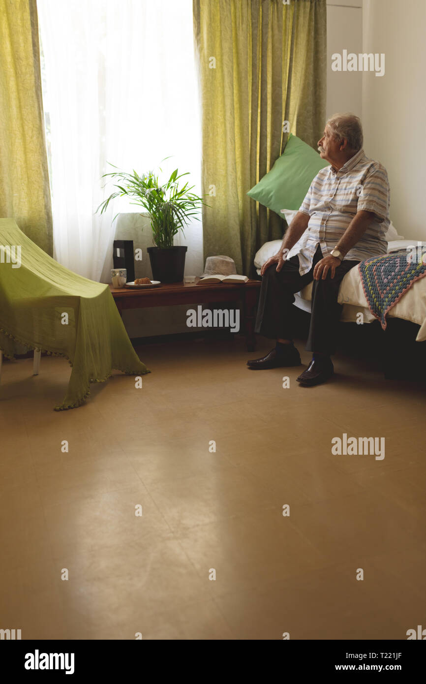 Sad old man looking window hi-res stock photography and images - Alamy