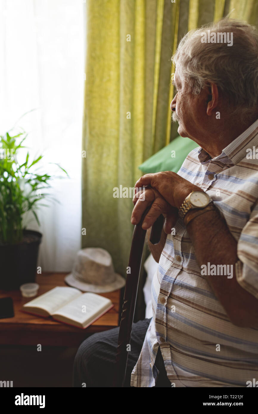 Senior man looking outside the window Stock Photo - Alamy
