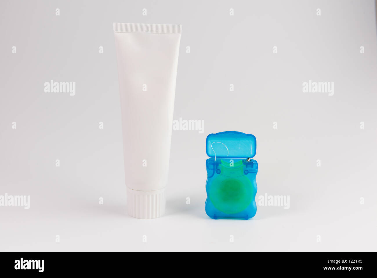 White tooth gel container with floss container isolated on white ...