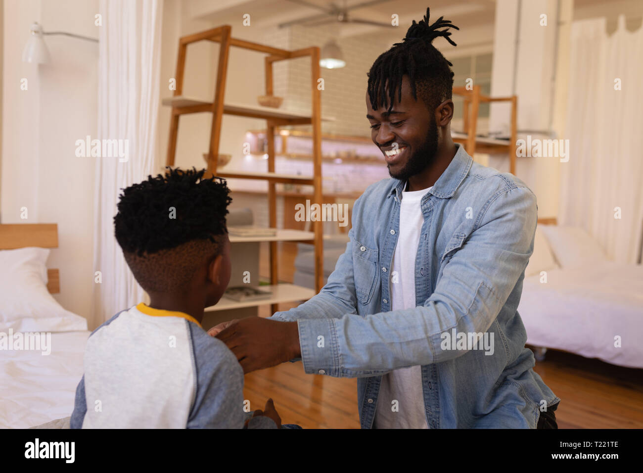 Father dressing his son at home Stock Photo - Alamy