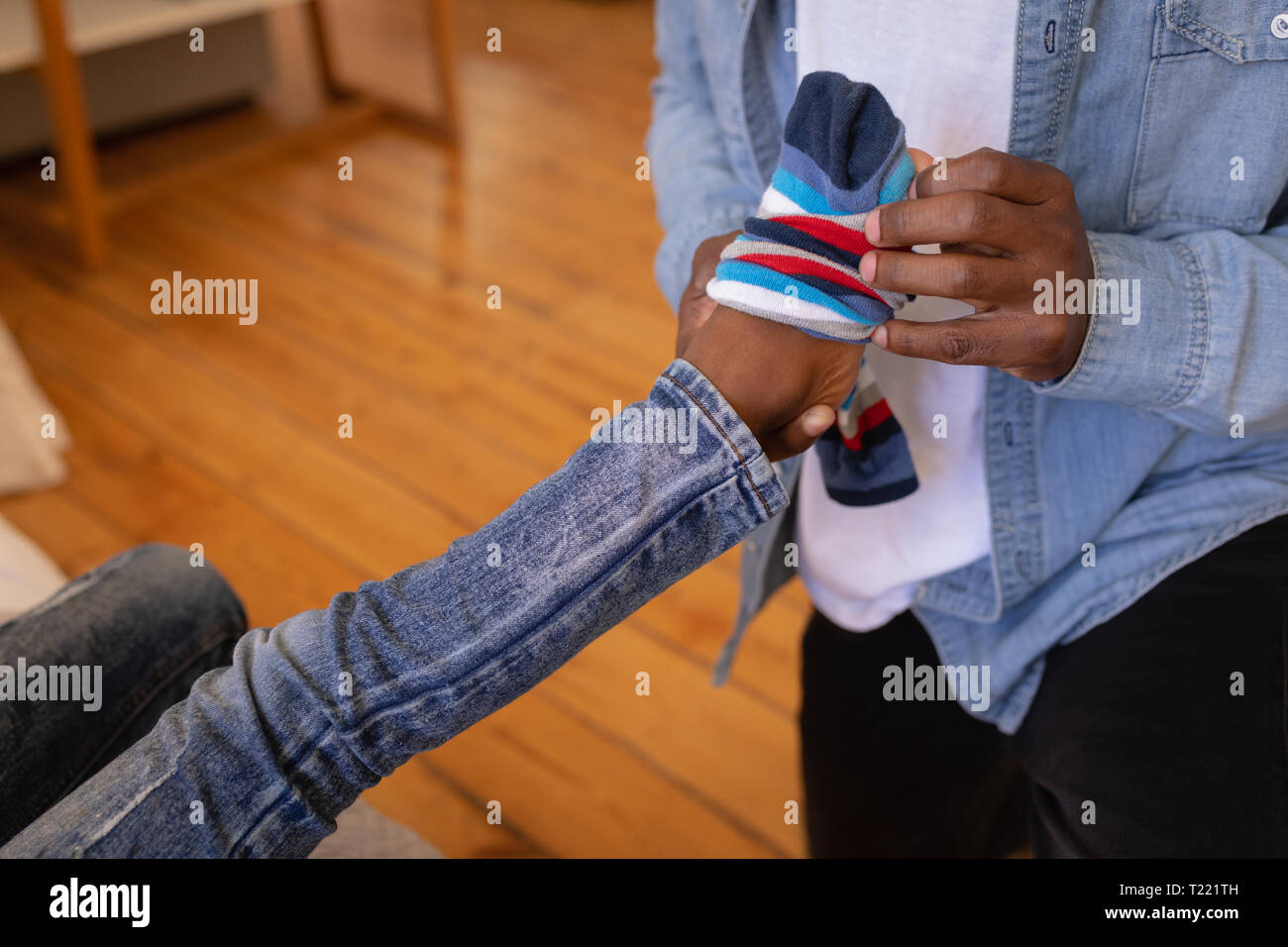 Father dressing his son at home Stock Photo - Alamy