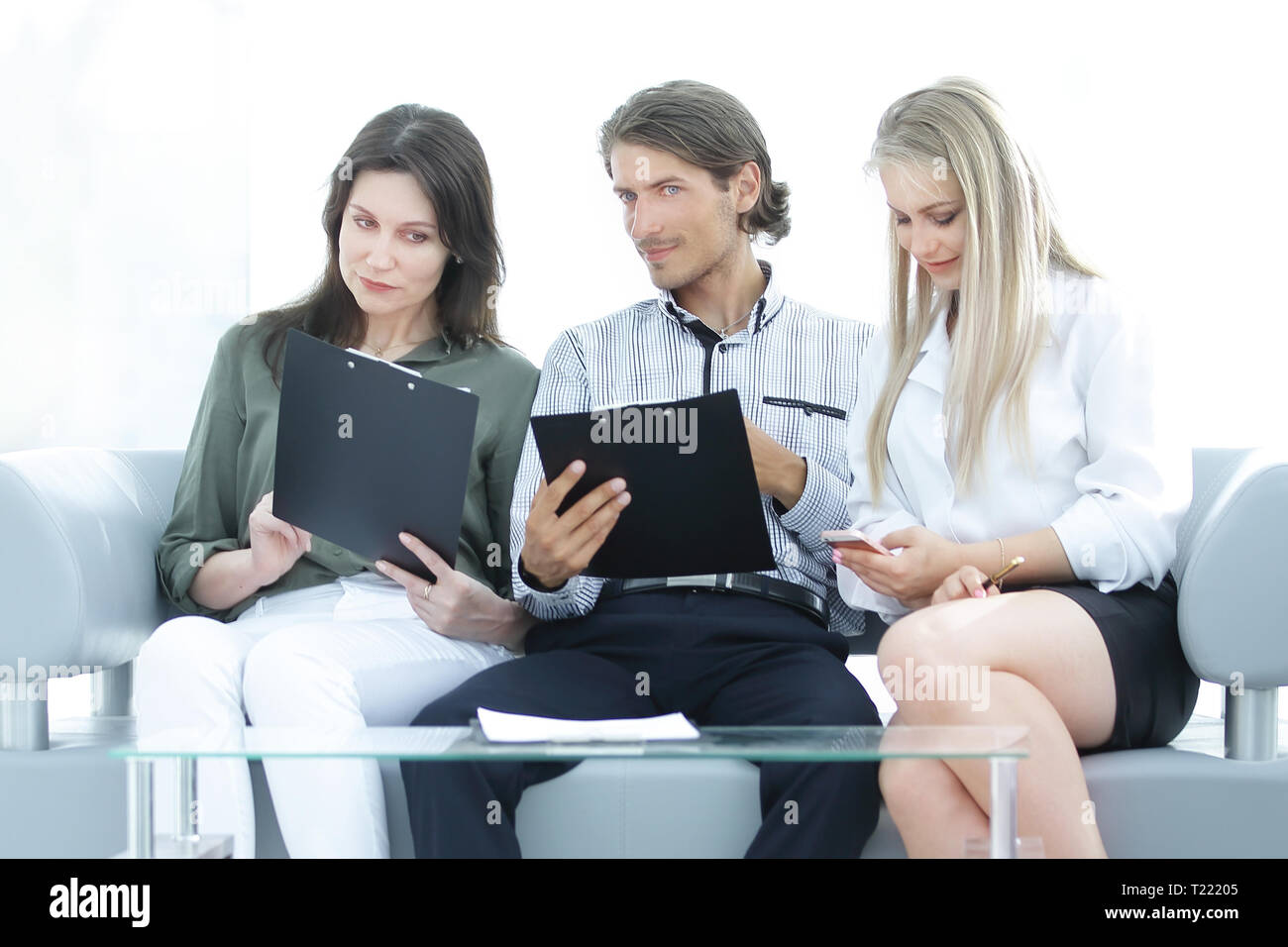 business team reading work documents Stock Photo - Alamy