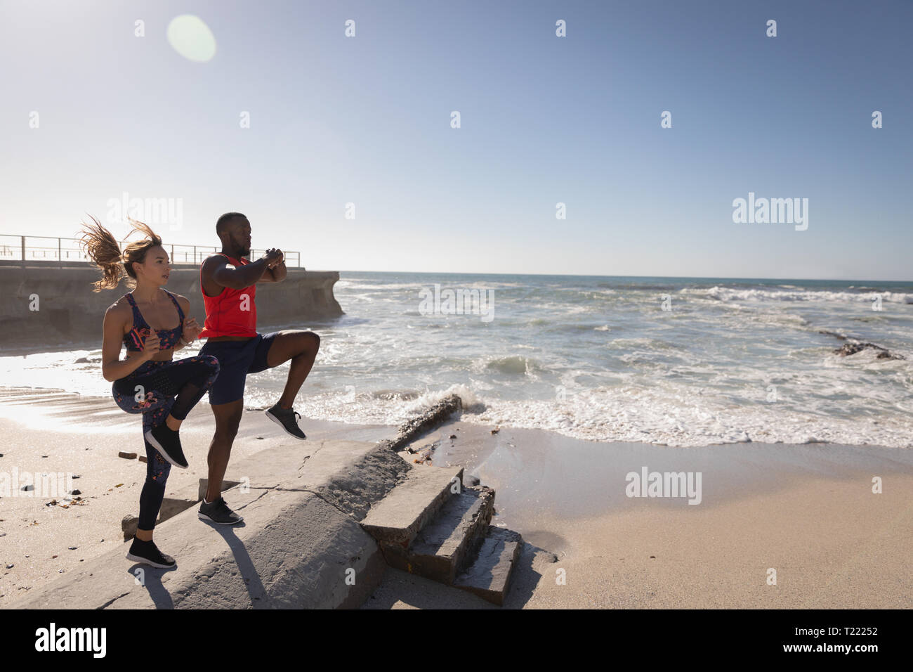 Couple doing spot jogging at beach Stock Photo - Alamy
