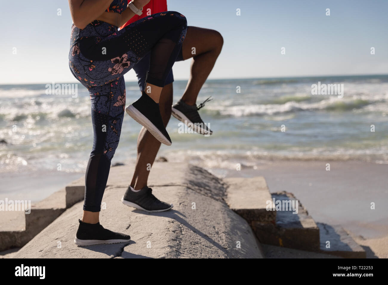 Couple doing spot jogging at beach Stock Photo - Alamy