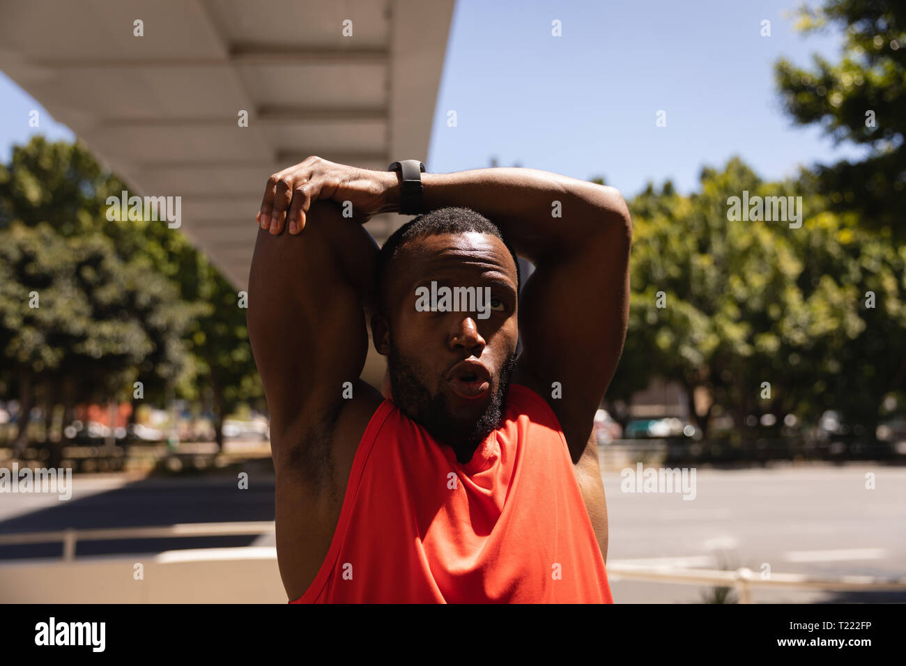 Man doing hand stretch exercise at pavement under the bridge Stock ...