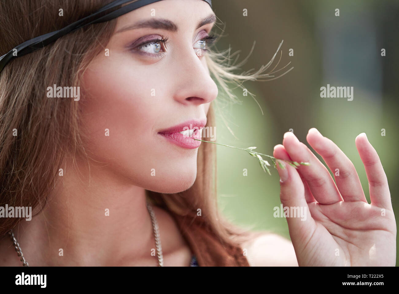 close up.portrait of a female hippie on blurred background of forest ...