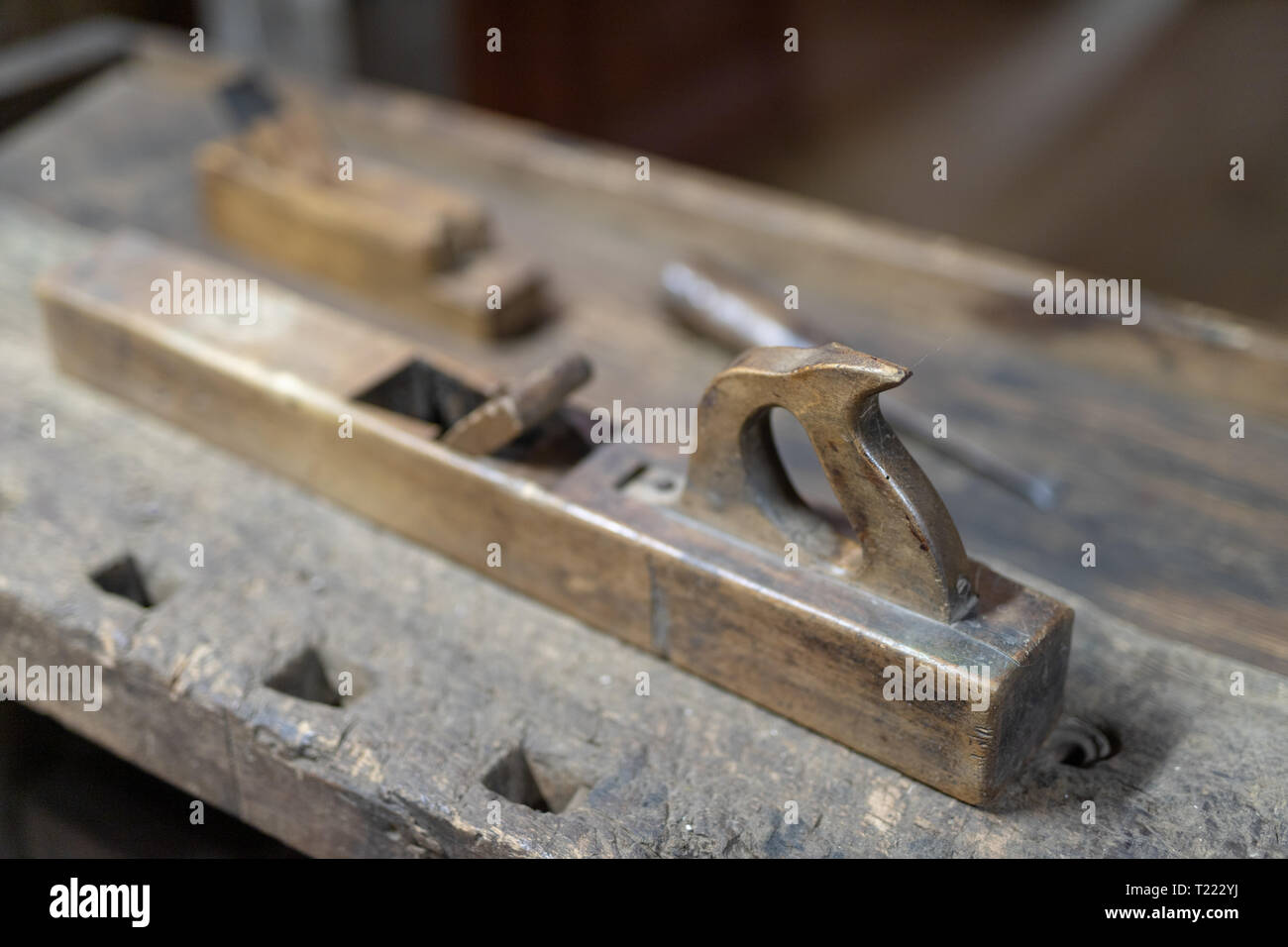 Old planer on a wooden carpentry table. DIY accessories in an old ...