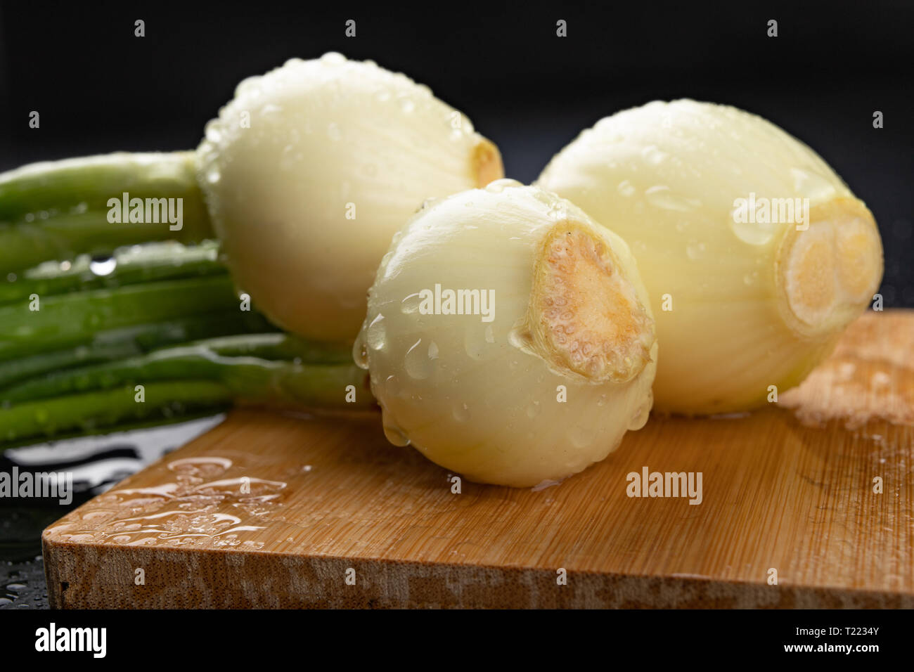 Fresh wet young onion on the kitchen table. Sliced chives on a kitchen ...
