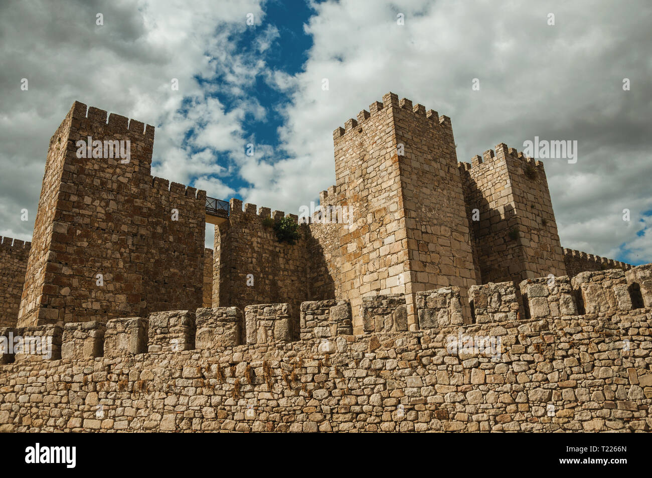 Towers and stone walls with merlons at the Castle, also called Alcazaba ...
