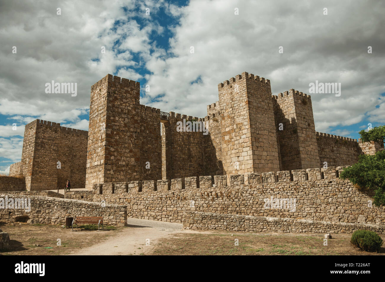 Towers and stone walls with merlons at the Castle, also called Alcazaba ...
