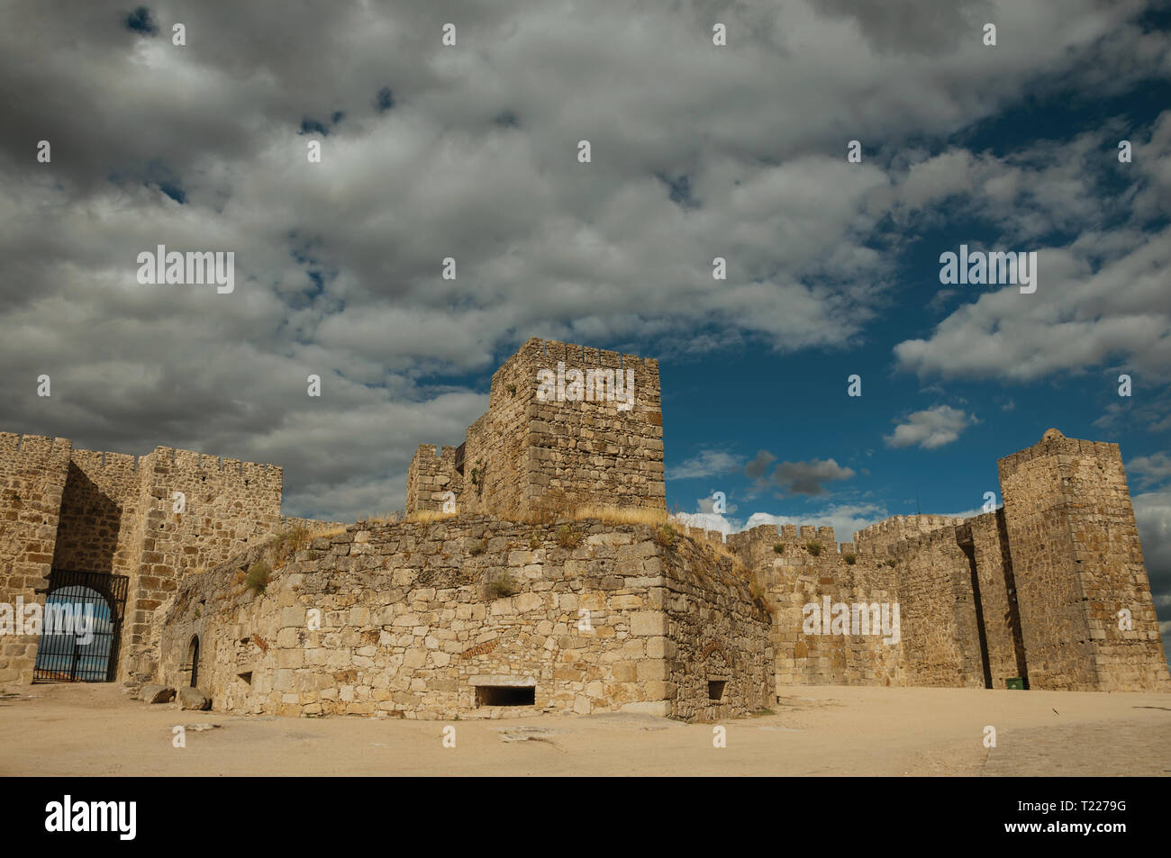 Towers and stone walls with merlons at the Castle, also called Alcazaba ...