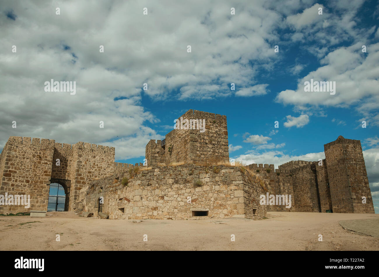 Towers and stone walls with merlons at the Castle, also called Alcazaba ...