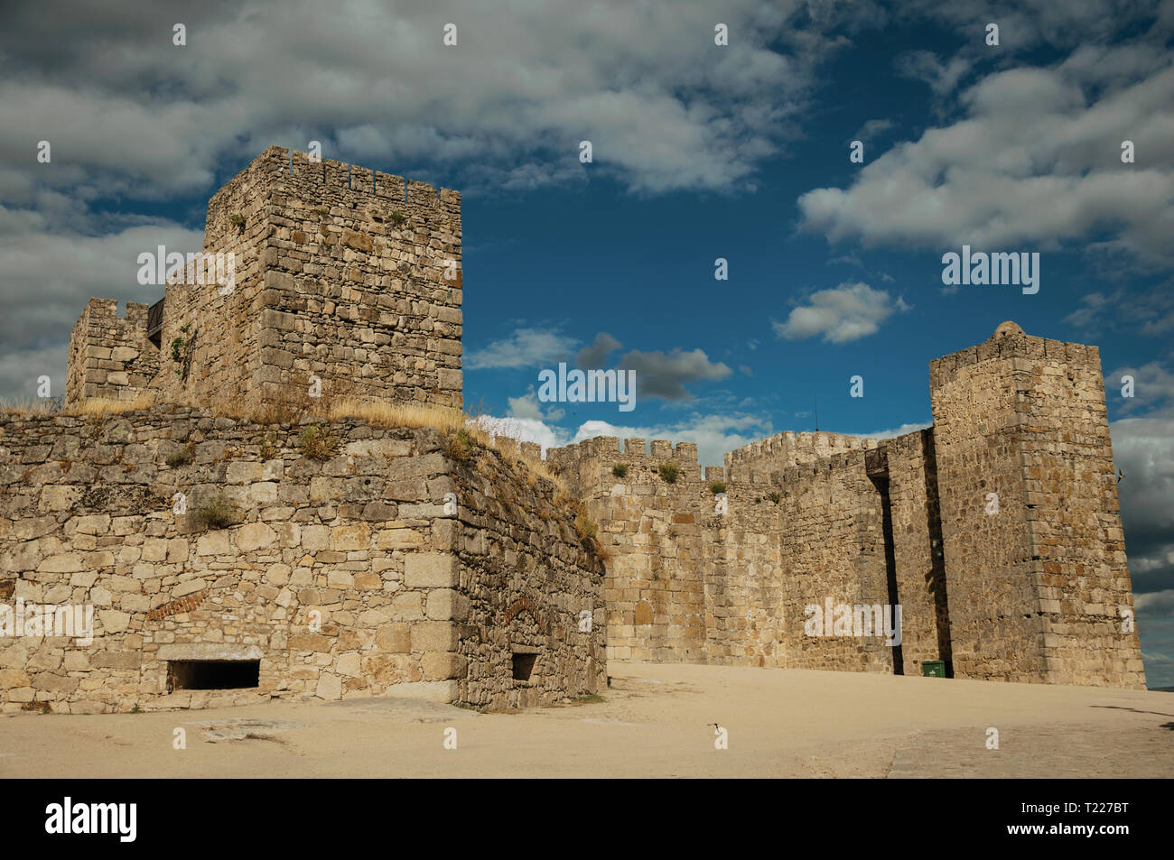 Towers and stone walls with merlons at the Castle, also called Alcazaba ...