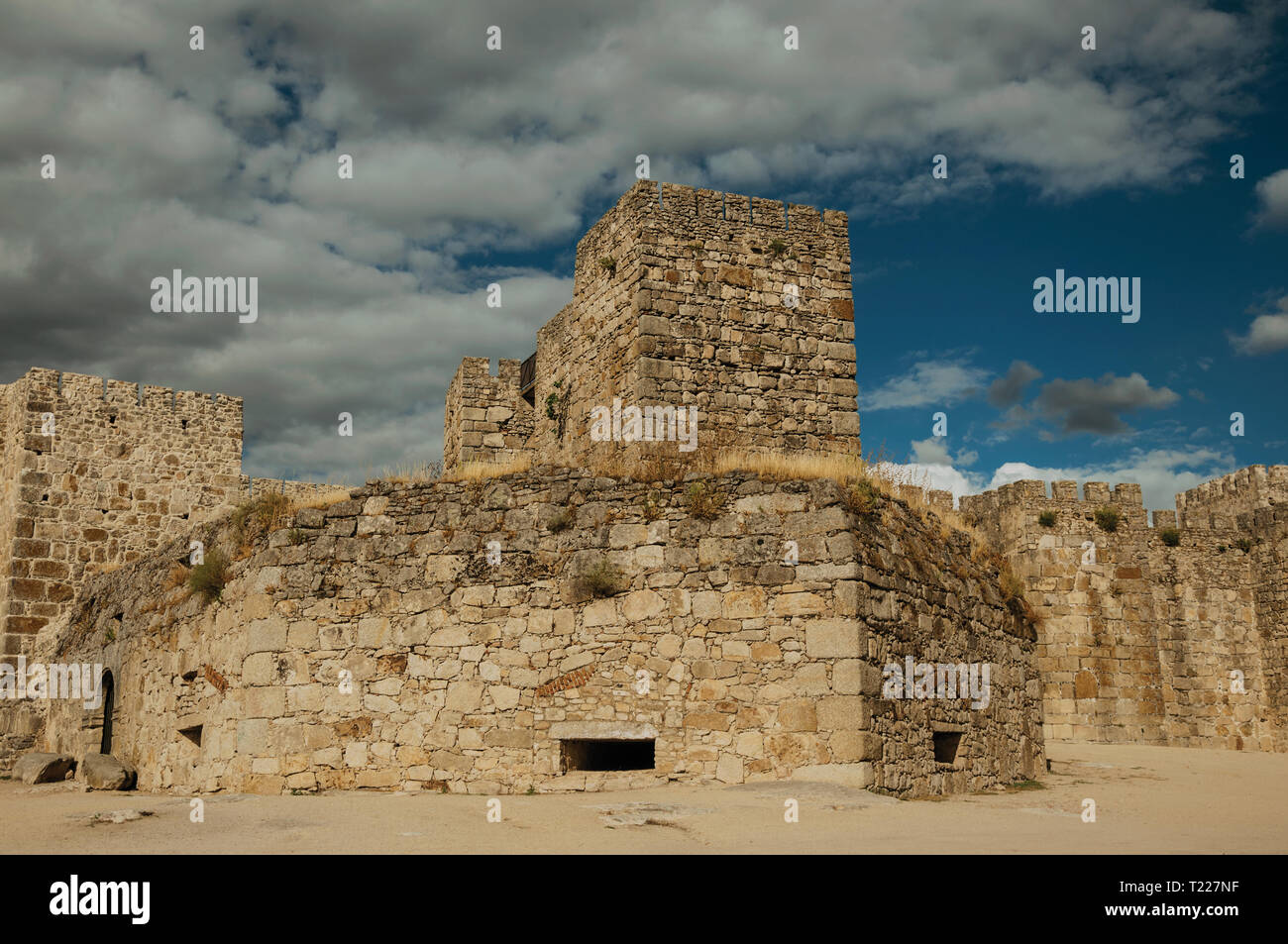 Towers and stone walls with merlons at the Castle, also called Alcazaba ...