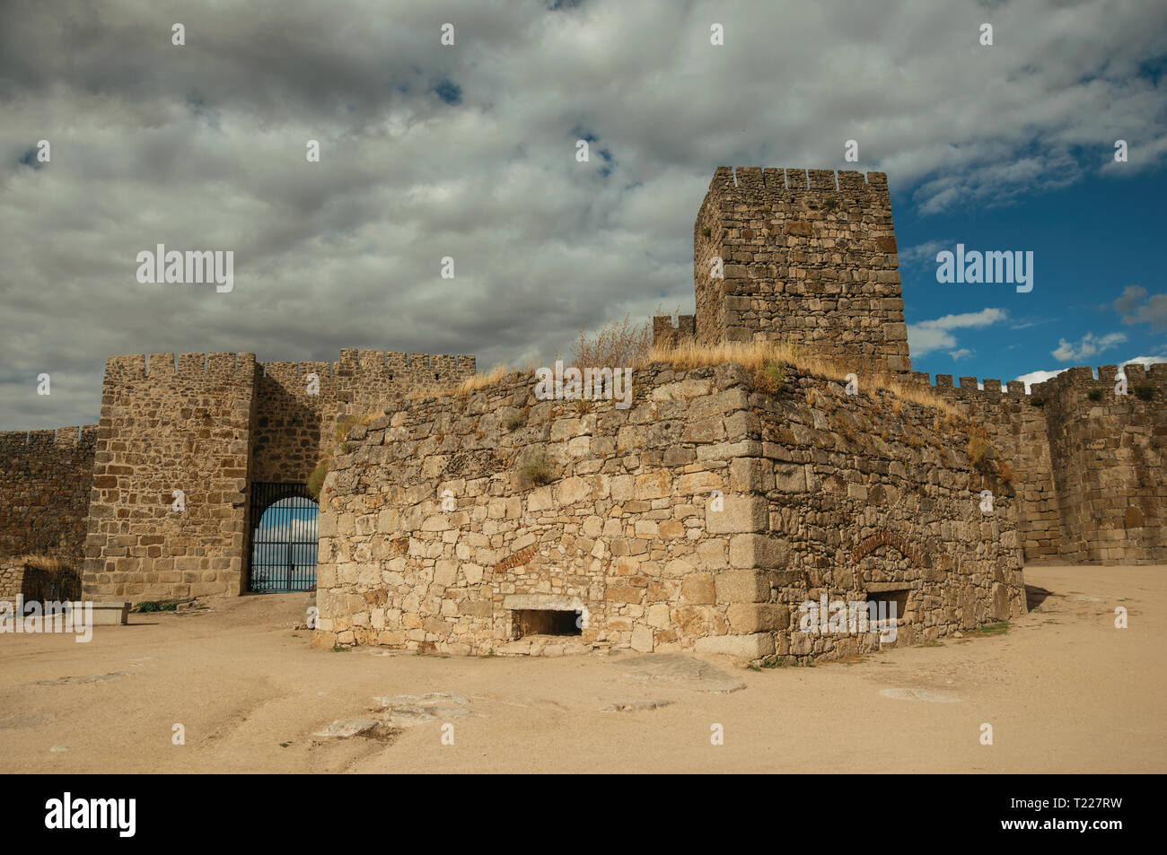 Towers and stone walls with merlons at the Castle, also called Alcazaba ...