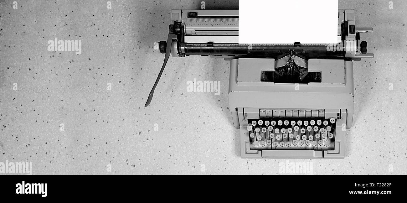 A photo of an old typing device with white paper Stock Photo - Alamy