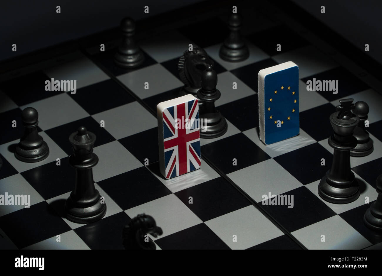 Backlit in the shadows figures and flags of the European Union and ...