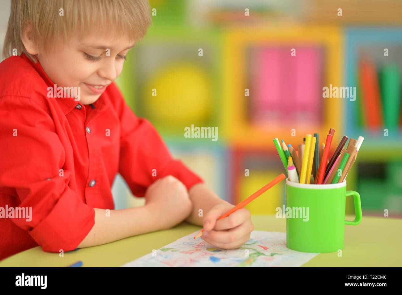 Portrait of cute little boy drawing with pencils Stock Photo - Alamy
