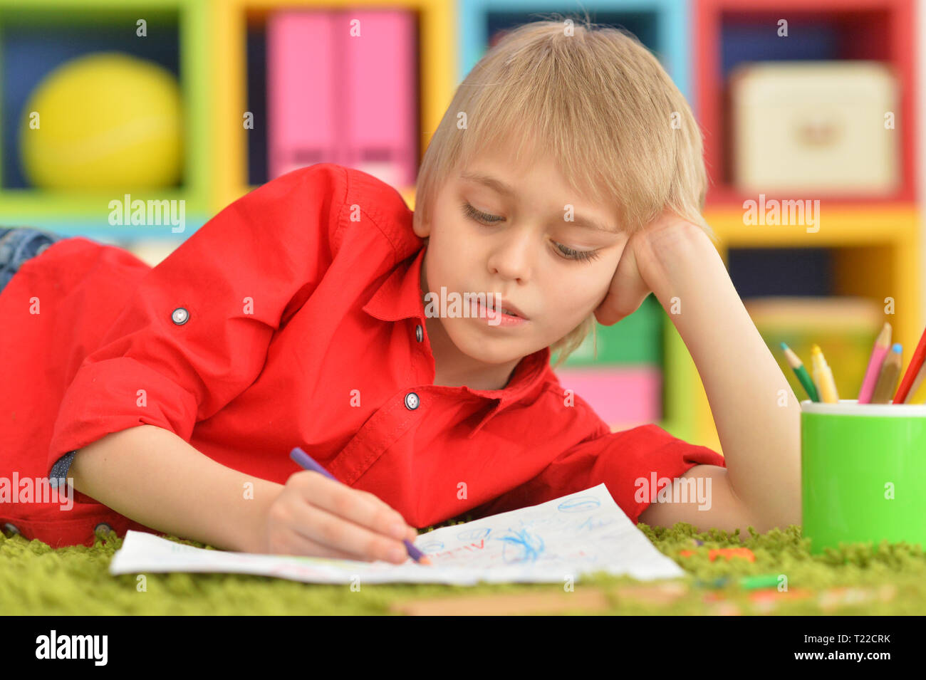 Portrait of cute little boy drawing with pencils at home Stock Photo ...