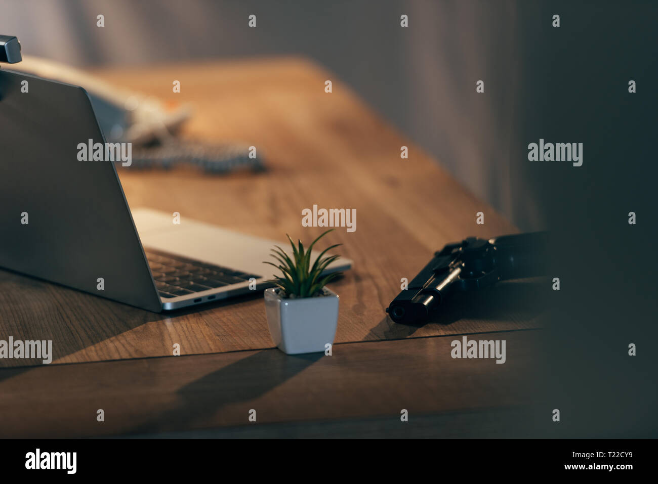 Gun on table in dark hi-res stock photography and images - Alamy