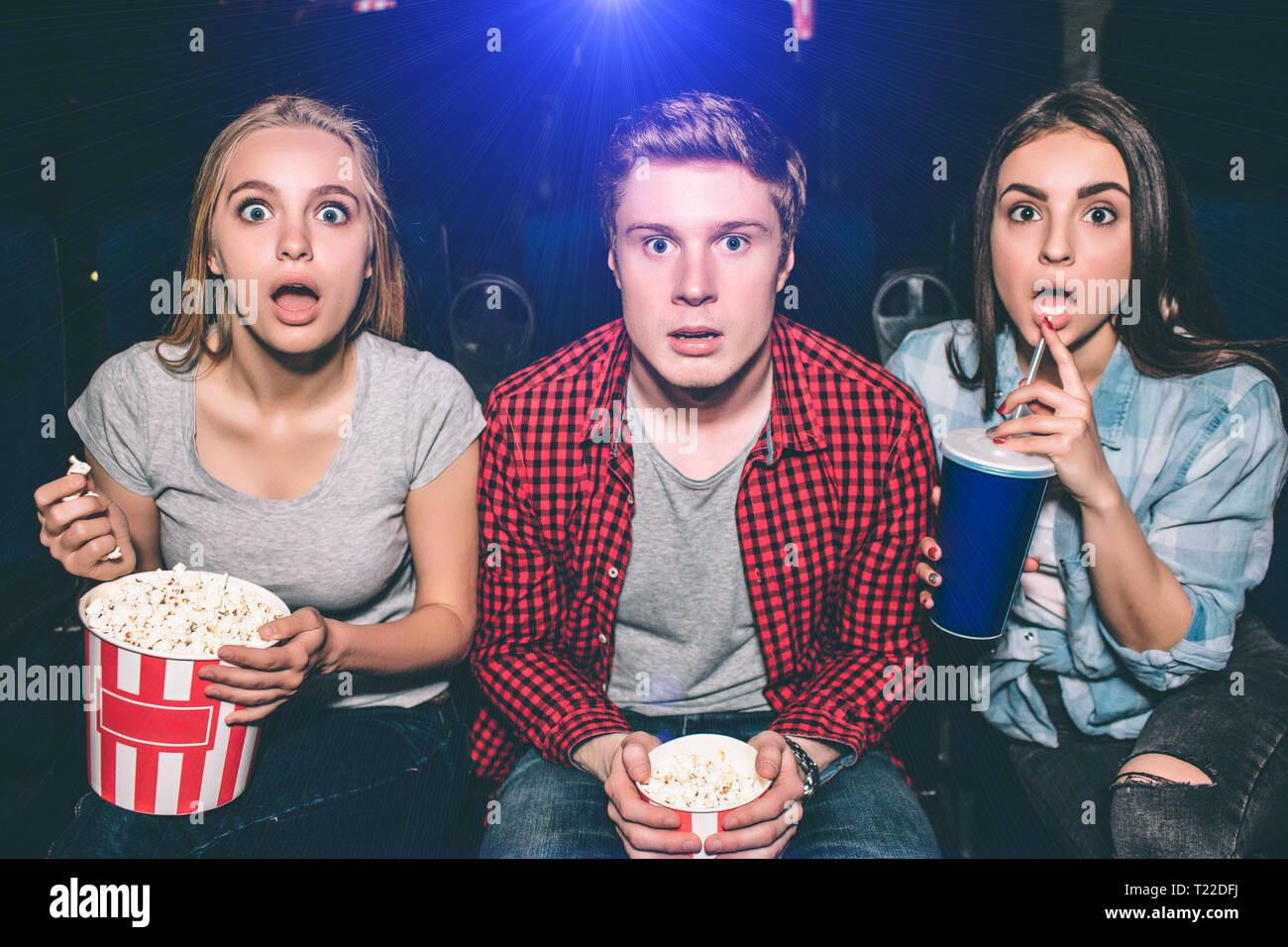 A picture of surprised and amazed young people looking to the camera ...