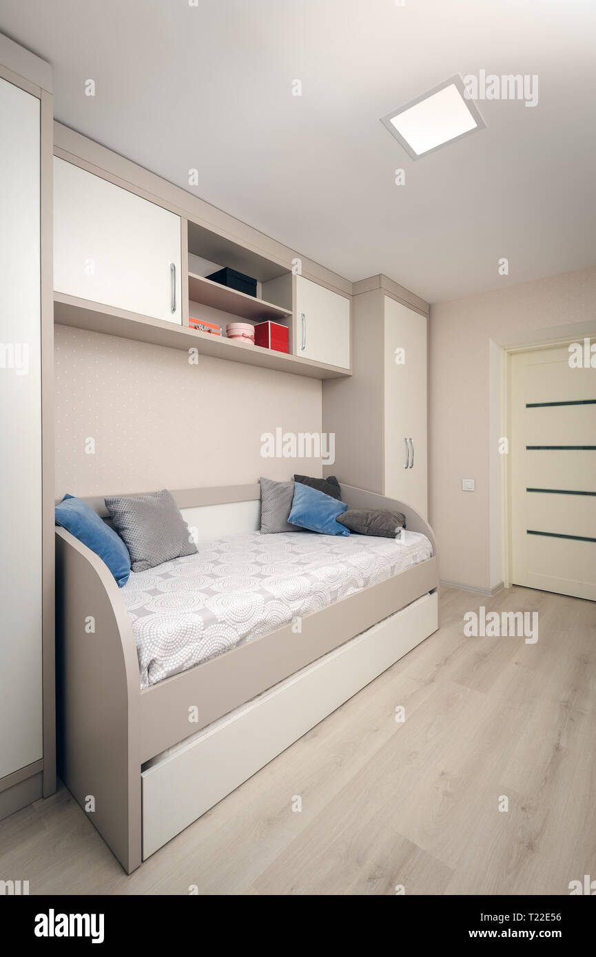 Modern bedroom with sofa and wardrobe Stock Photo - Alamy