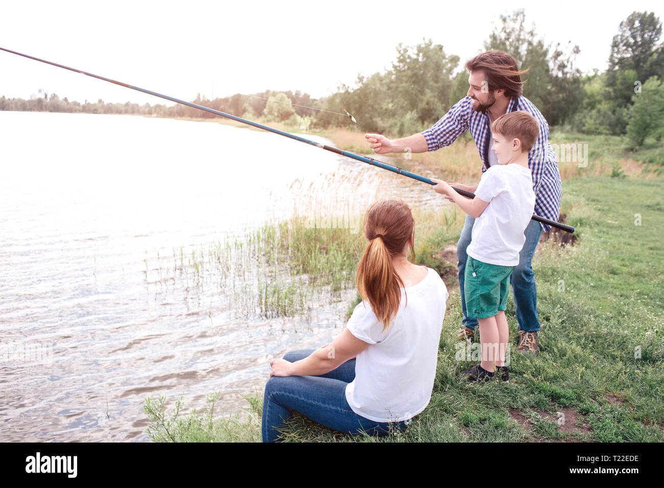 Father and mother teaching little boy how to fish hi-res stock ...