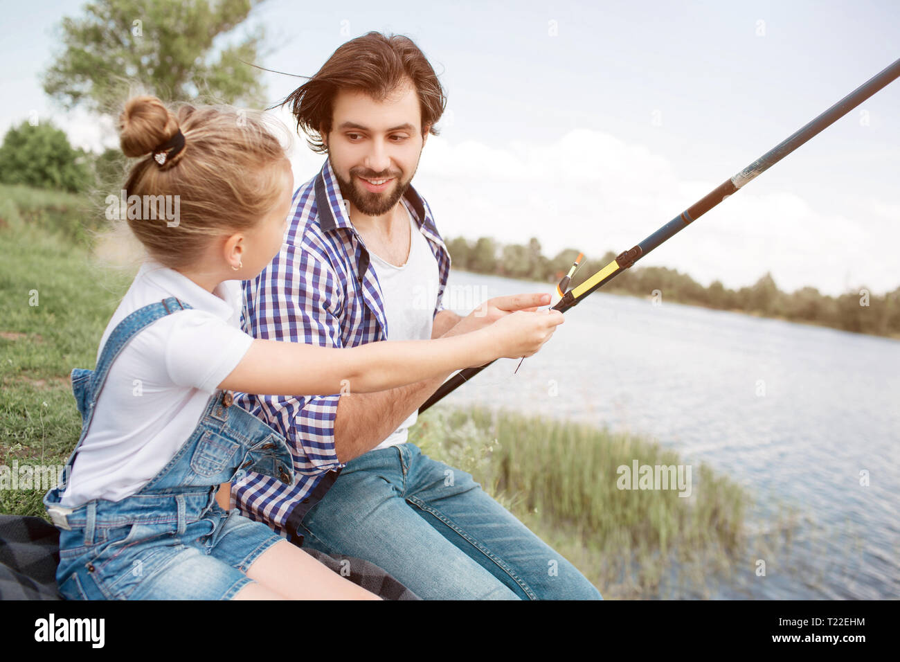 A picture of girl asking his dad about fishing for a bit. She wants to ...
