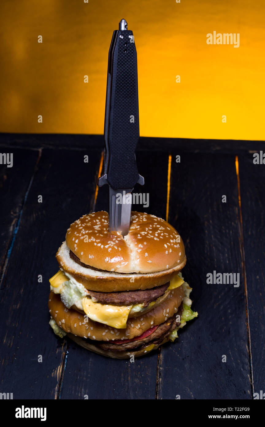 Burger with meat pierced with a knife. View of the burger from above ...