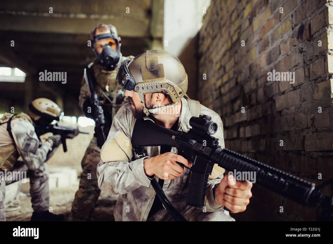 A picture of guy looking for an aim. He is loooking through loop gun ...