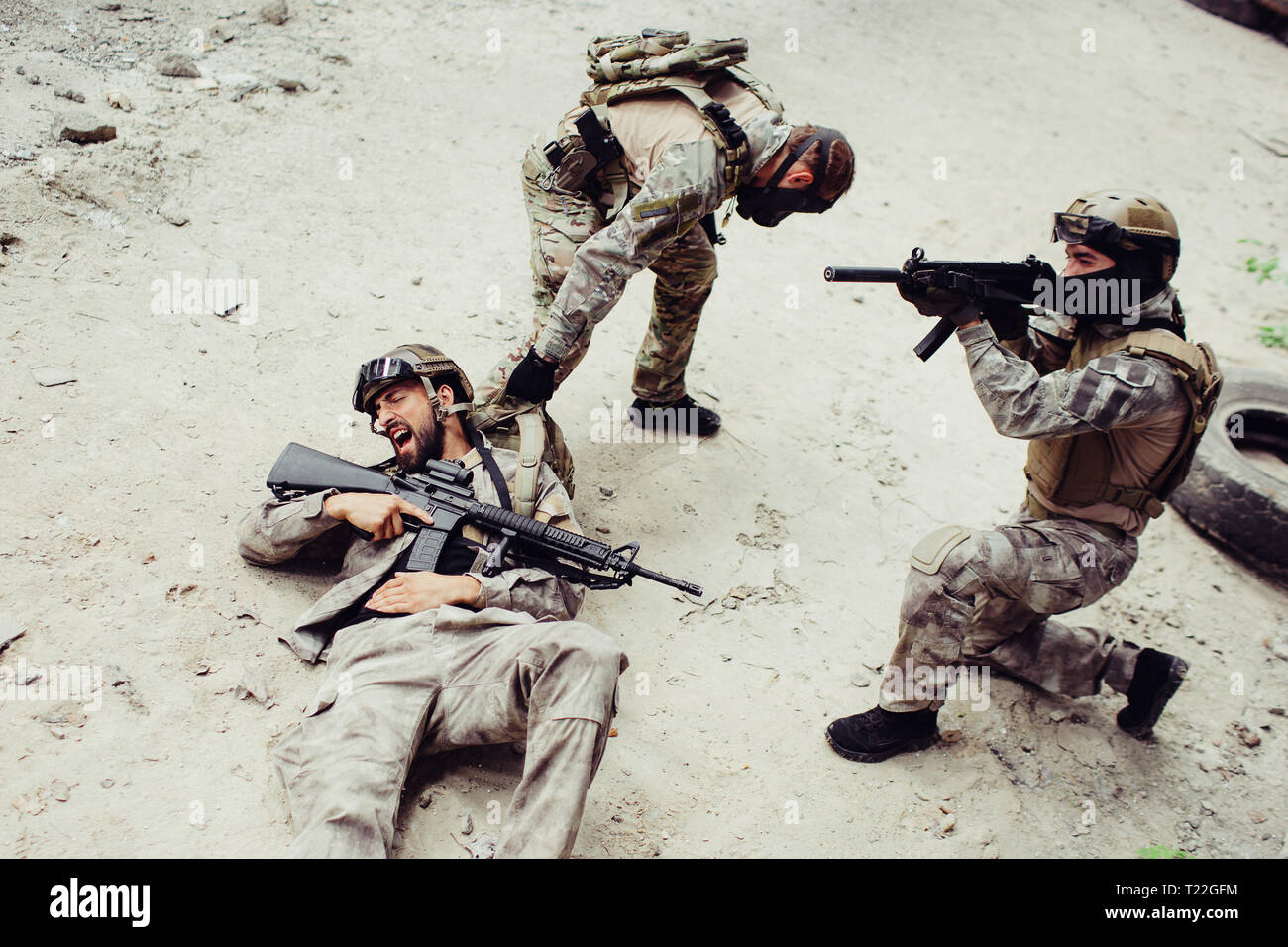 Dramatic picture of guy got wounded. His comrade is trying to pull him ...