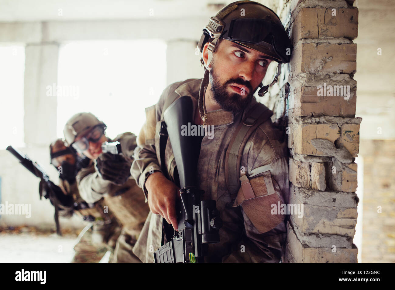 Serious and careful man is leaning to wall. He is aiting. There are his ...