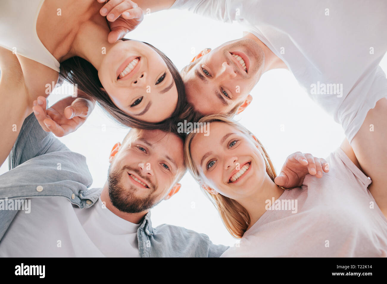 Vertical picture of happy and positive young men and women standing ...