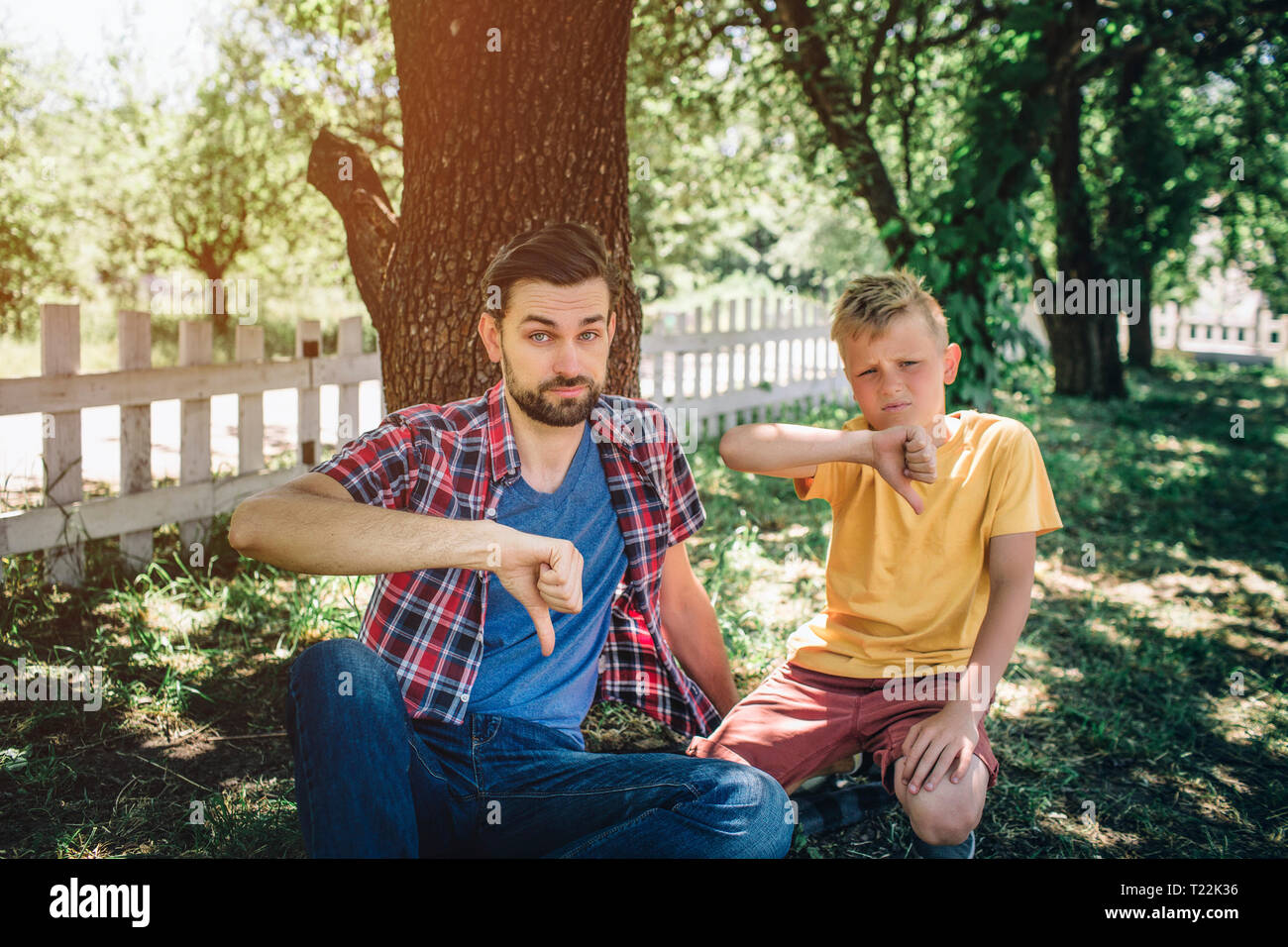 Two boys looking down sad hi-res stock photography and images - Alamy