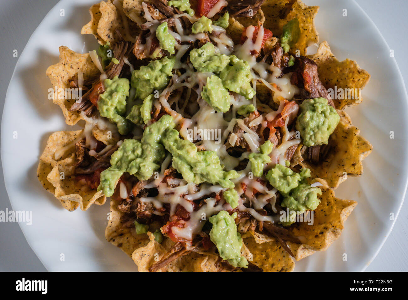 homemade mexican avocado cheese meat nachos Stock Photo - Alamy