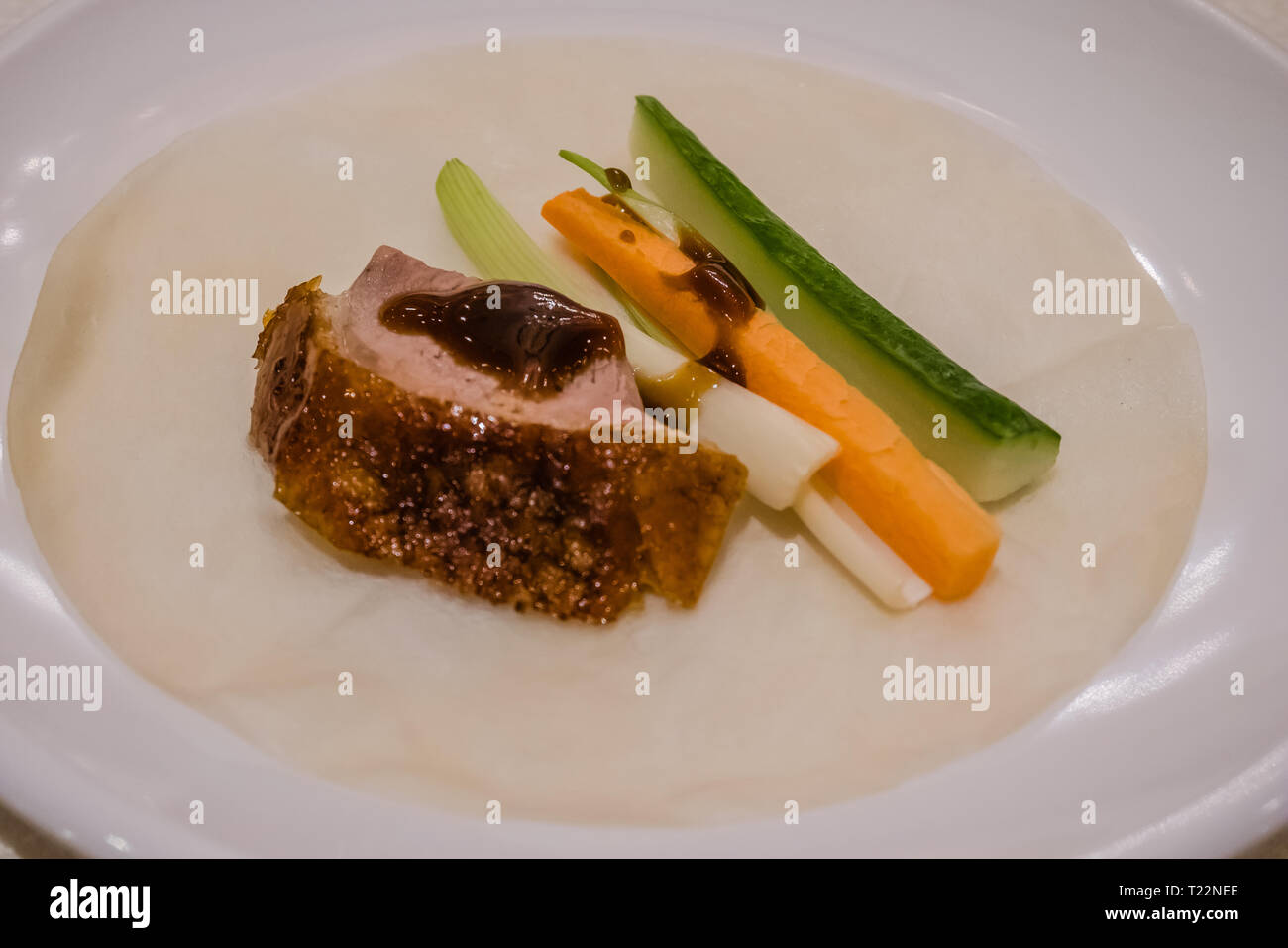 traditional chinese dish cripsy peaking duck slice served with green ...
