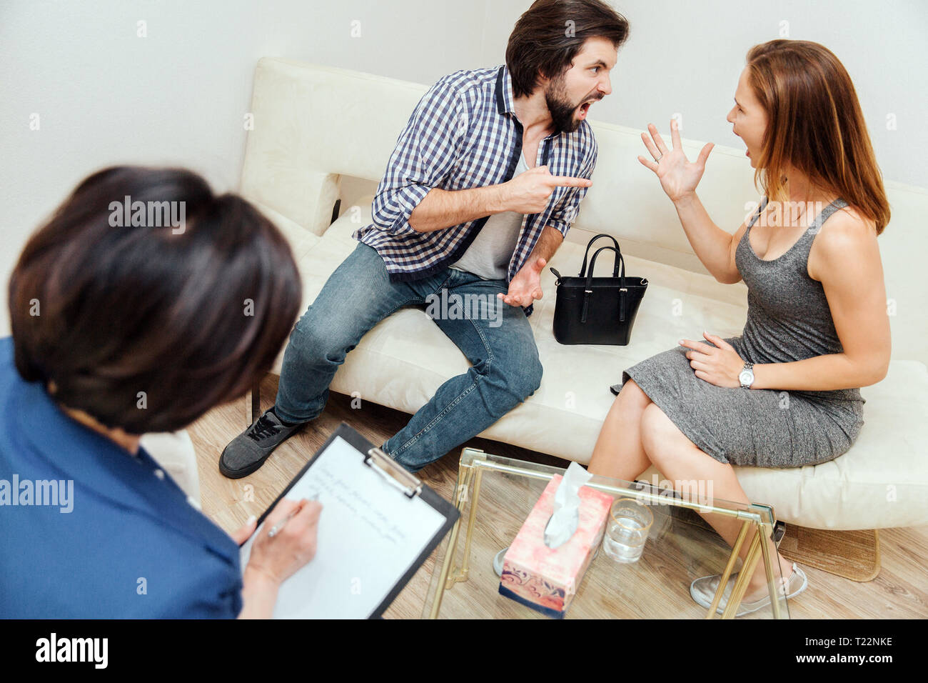 A picture of angry couple screaming and yelling to each other. Both of ...