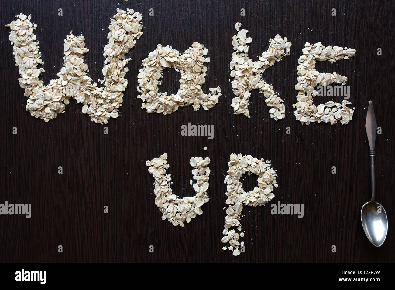 letters of oatmeal lined with words Wake up on the background of a dark ...