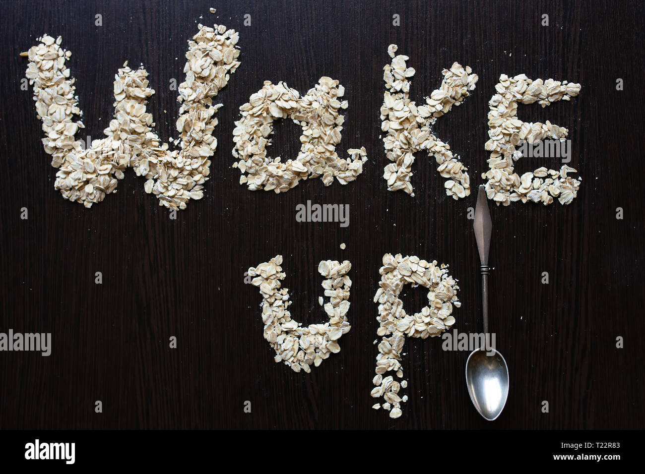 letters of oatmeal lined with words Wake up on the background of a dark ...