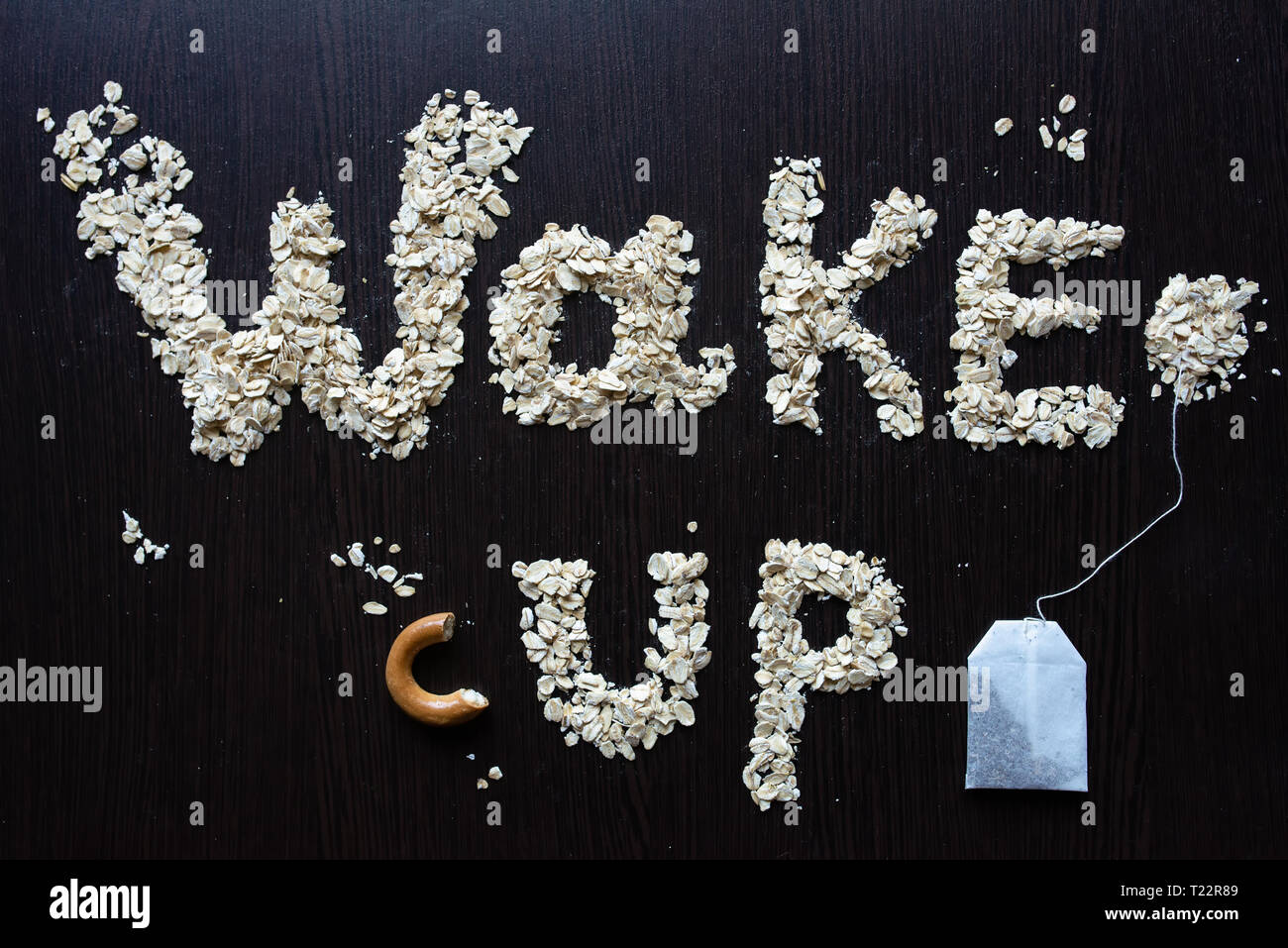 letters of oatmeal lined with words Wake up on the background of a dark ...