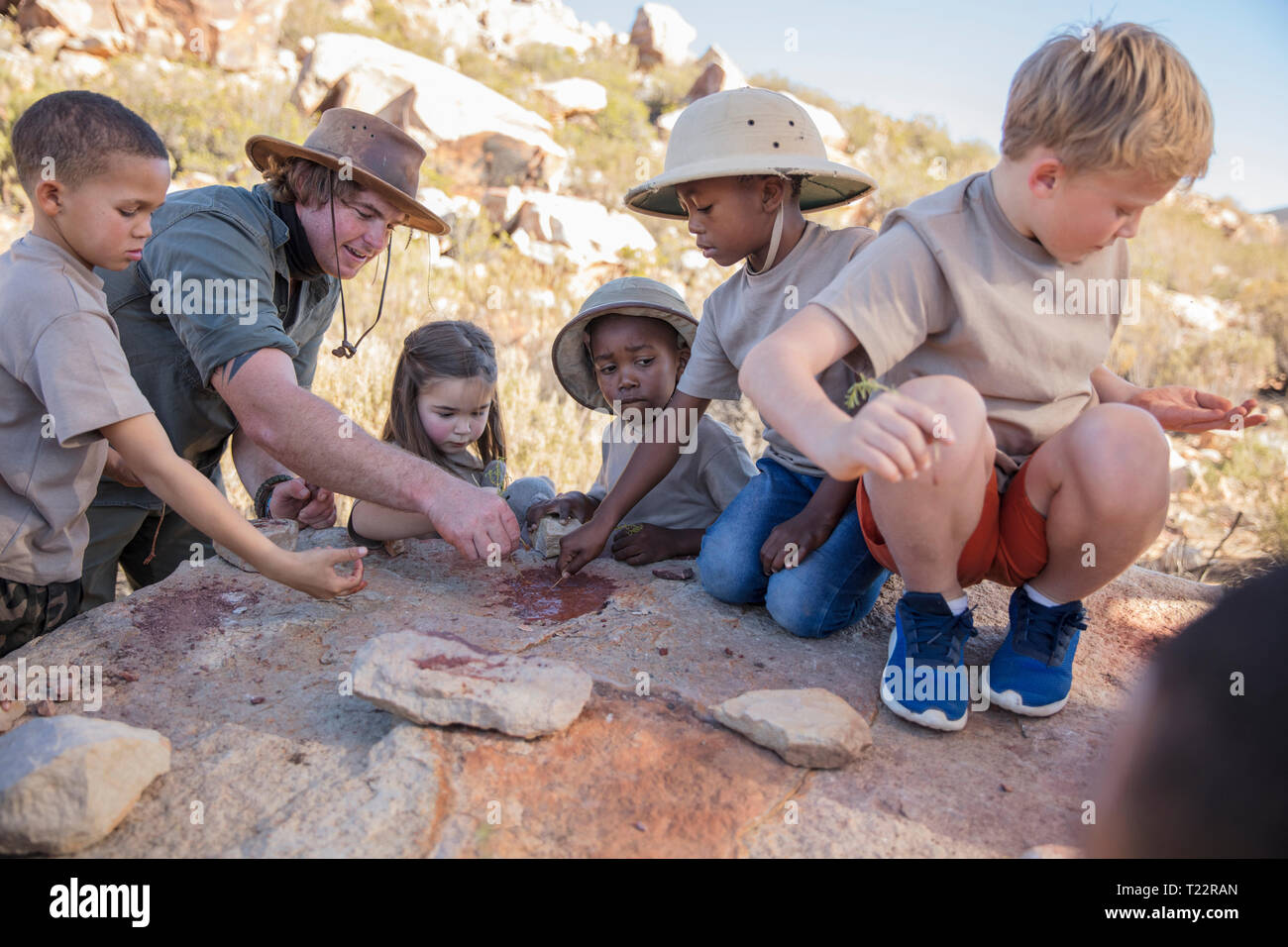 Children at a camp learning from guide Stock Photo - Alamy