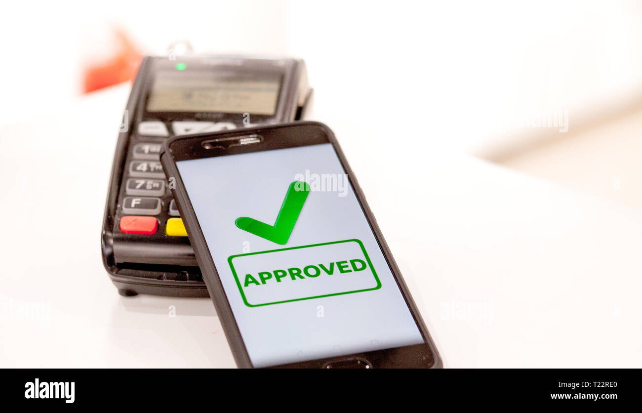 POS terminal, Payment Machine with mobile phone on store background ...