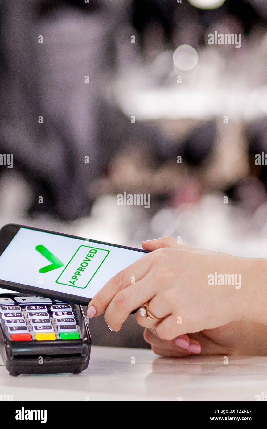 POS terminal, Payment Machine with mobile phone on store background ...